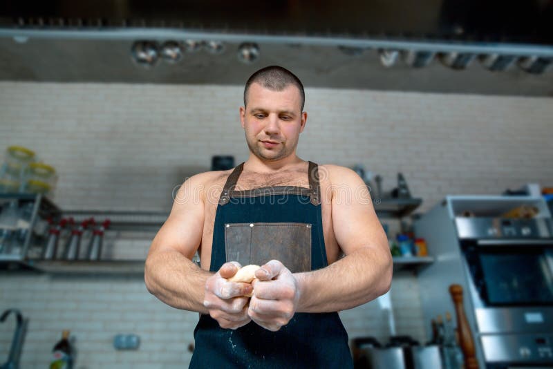 Bodybuilder Chef in Hotel or Restaurant Kitchen Knead the Dough on the ...