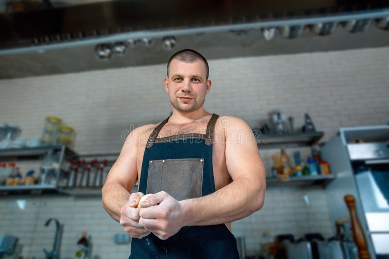 Bodybuilder Chef in Hotel or Restaurant Kitchen Knead the Dough on the ...