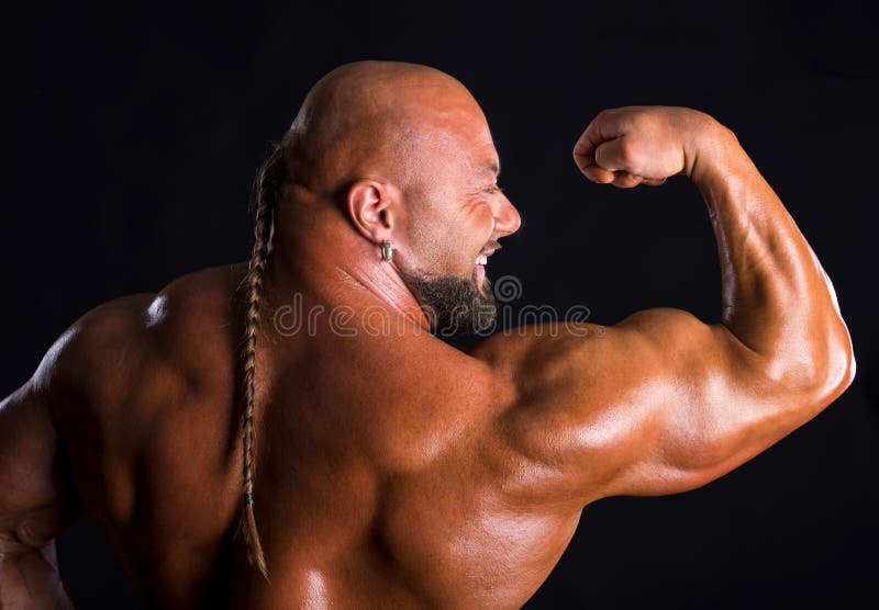 Bodybuilder Demonstrating Muscles of the Back and Arms Stock Image ...