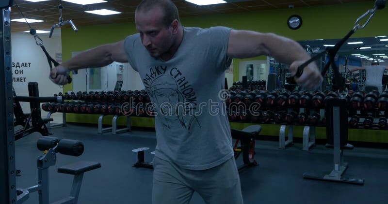 Bodybuilder Doing Butterfly on Cable Pull for Better Definition of His ...
