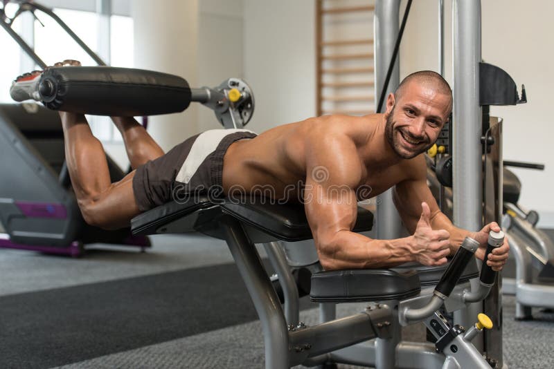 Bodybuilder Doing Lying Leg Curls Exercises on Machine Stock Photo ...