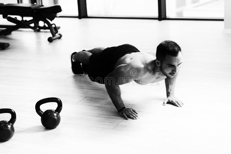 Bodybuilder Doing Push Ups on Floor with Kettle-bell Stock Image ...