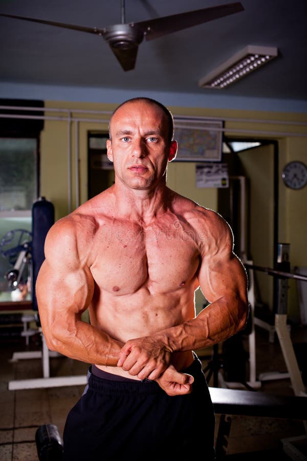 Bodybuilder posing in gym stock photo. Image of bodybuilder - 9771530