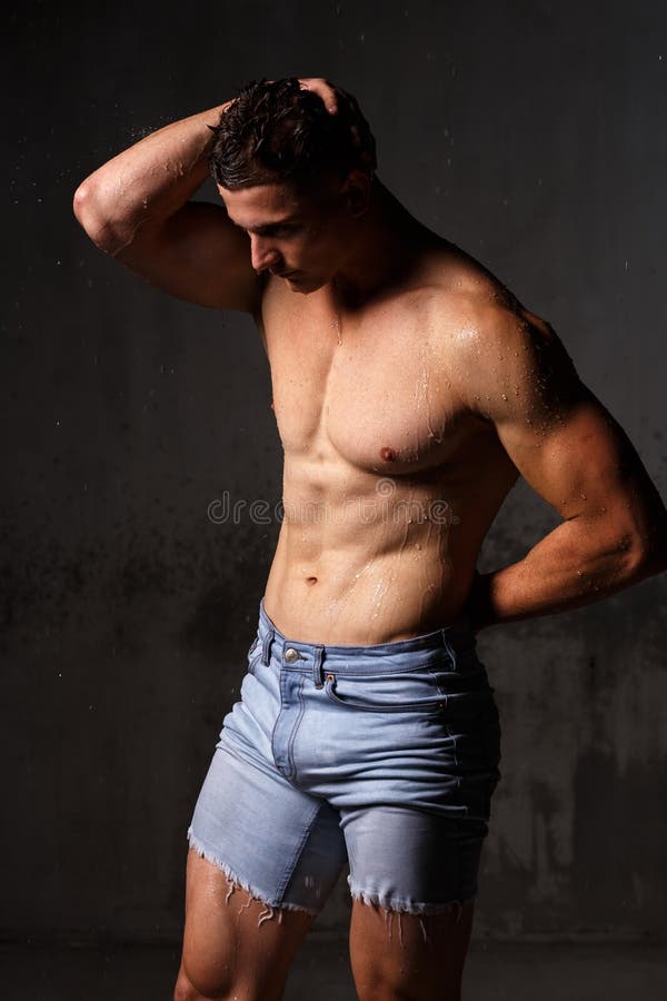 Athlete Bodybuilder Trains in the Studio in the Rain. Stock Image ...