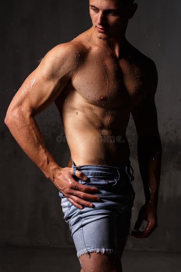 Athlete Bodybuilder Trains in the Studio in the Rain. Stock Image ...