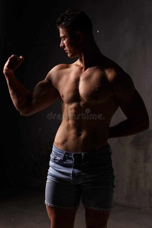 Athlete Bodybuilder Trains in the Studio in the Rain. Stock Photo ...