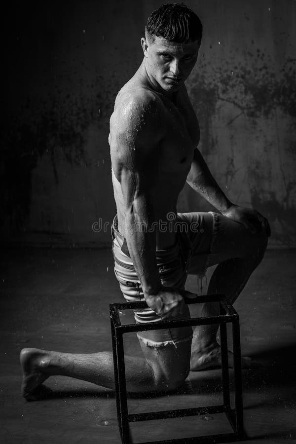 Athlete Bodybuilder Trains in the Studio in the Rain. Stock Image ...