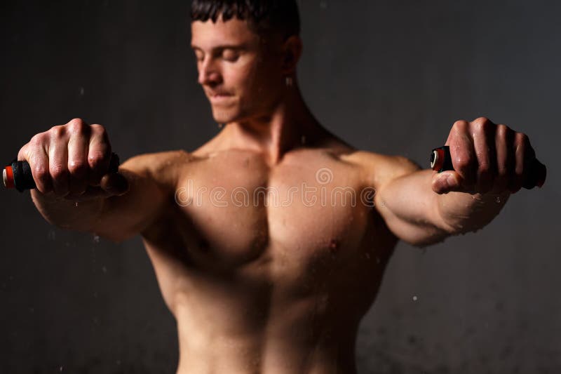 Athlete Bodybuilder Trains in the Studio in the Rain. Stock Photo ...