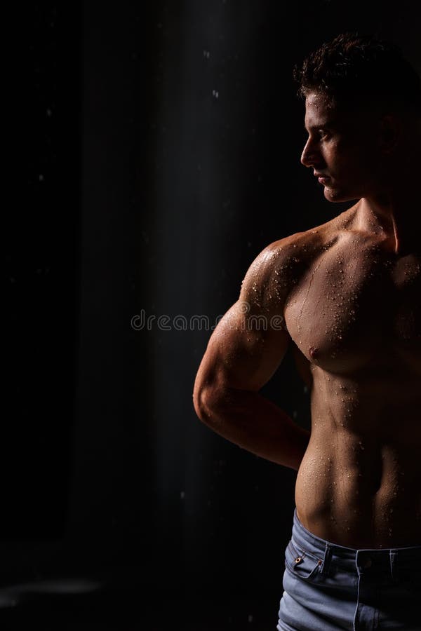 Athlete Bodybuilder Trains in the Studio in the Rain. Stock Photo ...