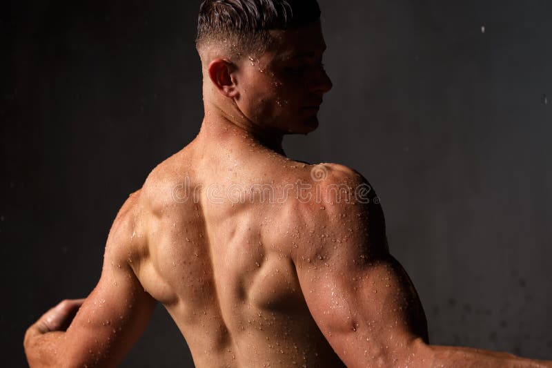 Athlete Bodybuilder Trains in the Studio in the Rain. Stock Photo ...