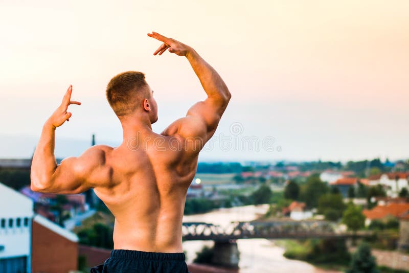 Bodybuilder Flexing Muscles on a Rooftop Stock Photo - Image of ...