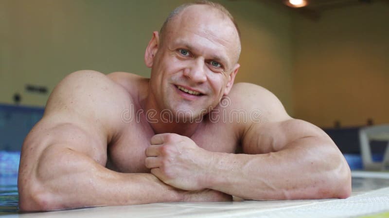 Bodybuilder in Indoor Pure Pool Looks at Camera Stock Video - Video of ...