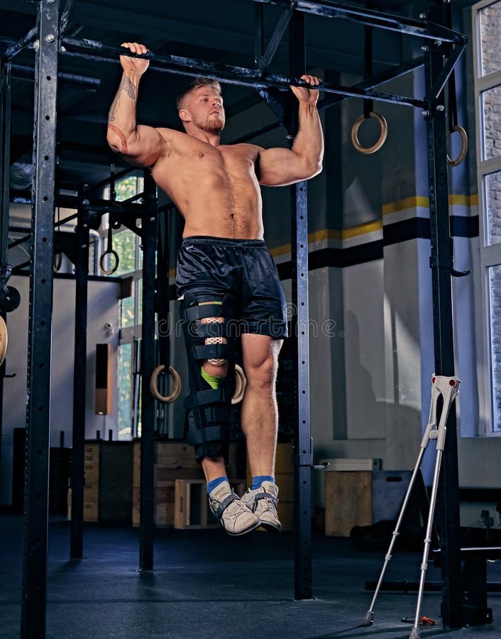 Bodybuilder with Injured Leg Doing Pull Ups. Stock Photo - Image of ...