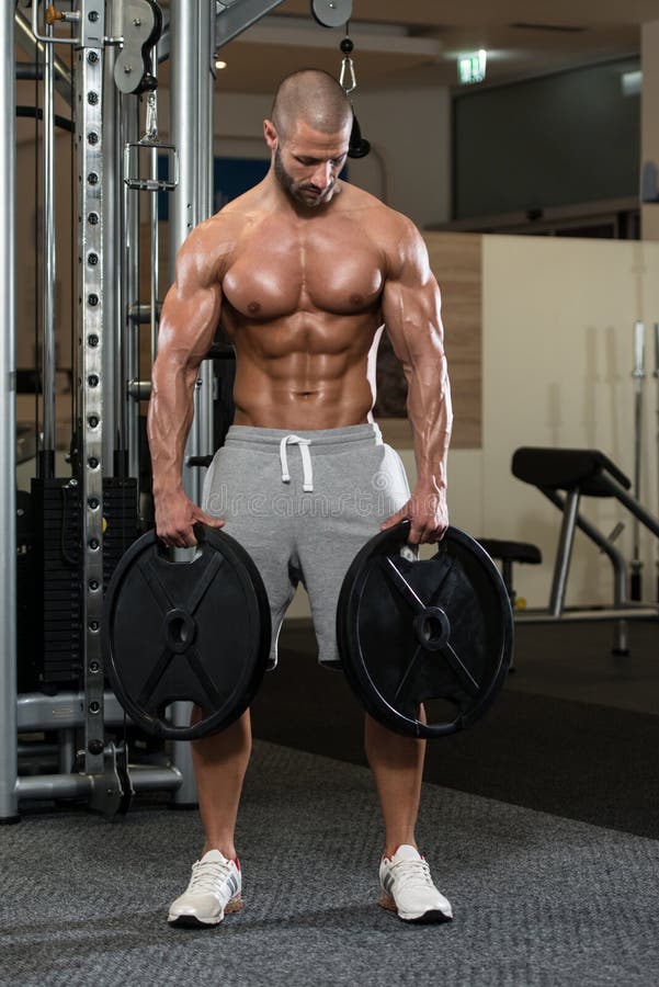 Bodybuilder Jugeant Des Poids Disponibles Image stock - Image du ...