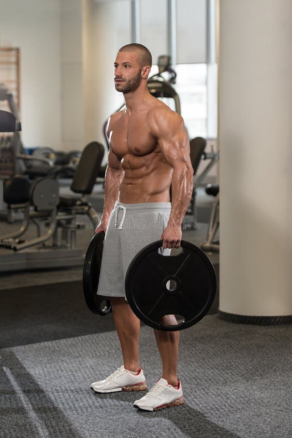 Bodybuilder Jugeant Des Poids Disponibles Image stock - Image du ...