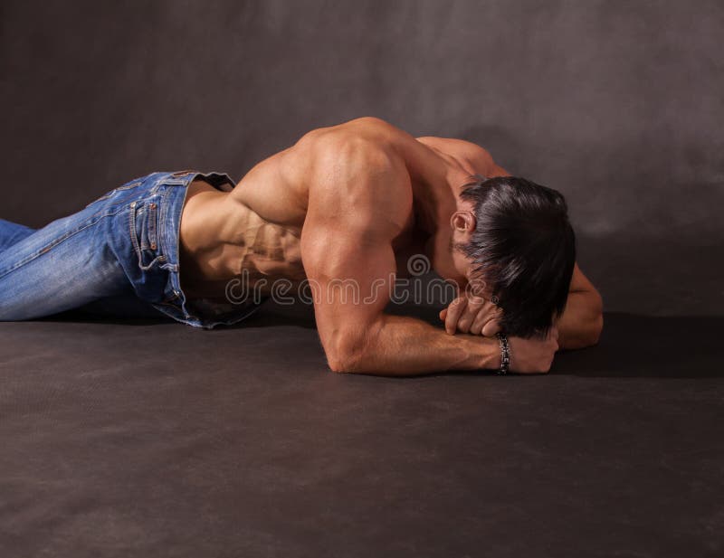 Bodybuilder Lying on the Floor in the Studio Stock Photo - Image of ...