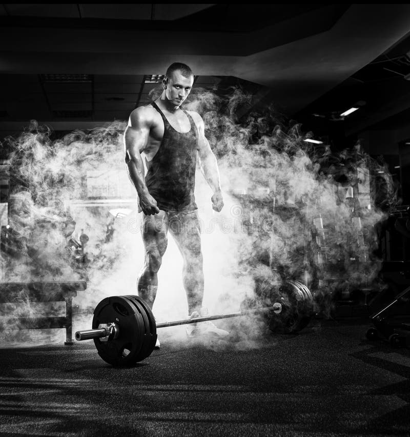 Bodybuilder Man Standing with Barbell, Workout in Gym Stock Photo ...
