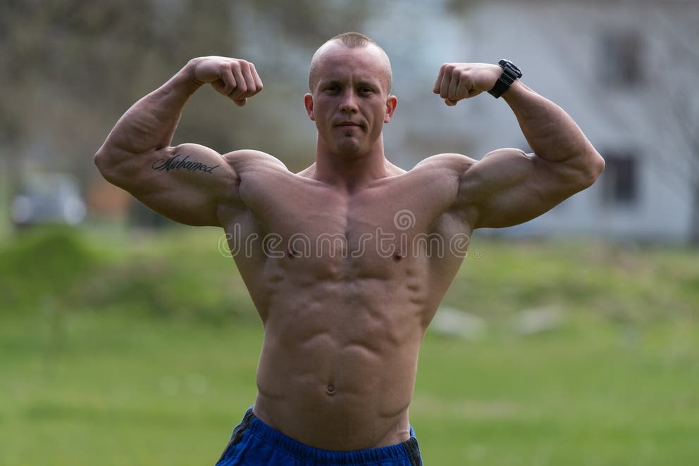Bodybuilder Performing Front Double Biceps Poses in Park Stock Image ...