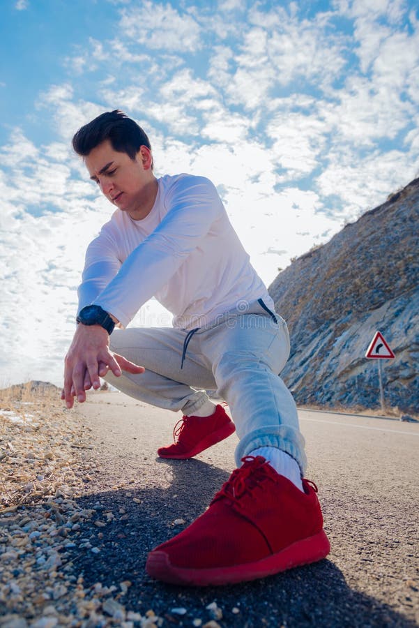 Bodybuilder Performing His Stretching Routine in the Morning on an ...