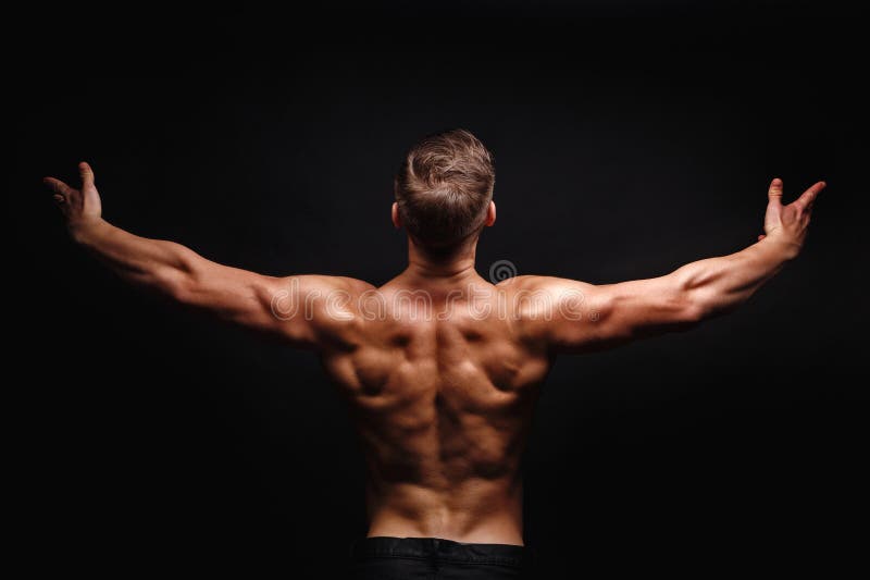 Bodybuilder Posing. Muscles the Shoulders and Back. Stock Photo - Image ...