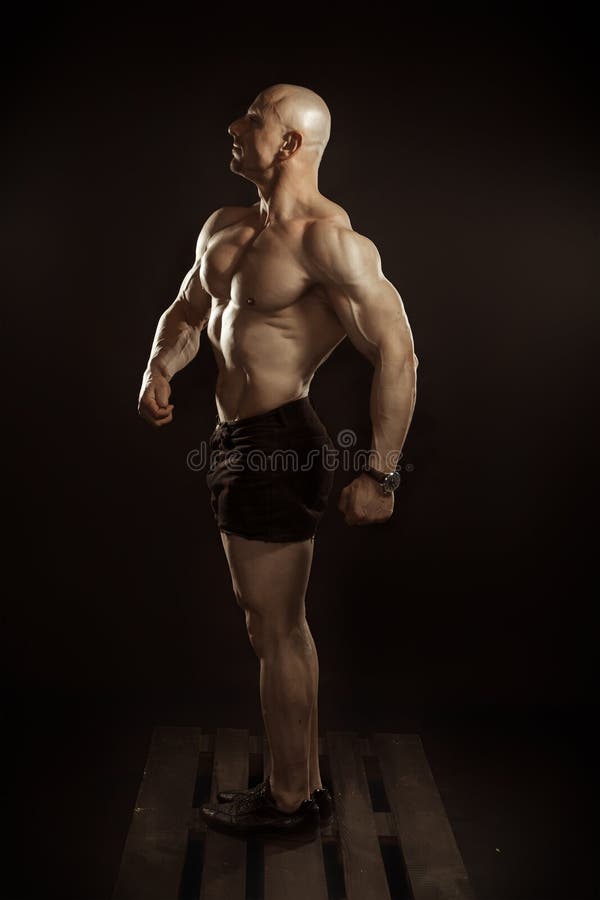 Bodybuilder Posing in Studio Side View Stock Photo - Image of power ...
