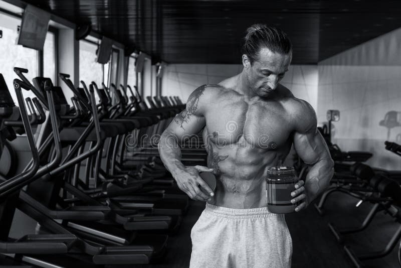 Bodybuilder Posing with Supplements for Copy Space Stock Photo - Image ...