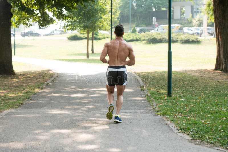 Handsome Body Builder Making Most Muscular Pose Stock Photo - Image of ...