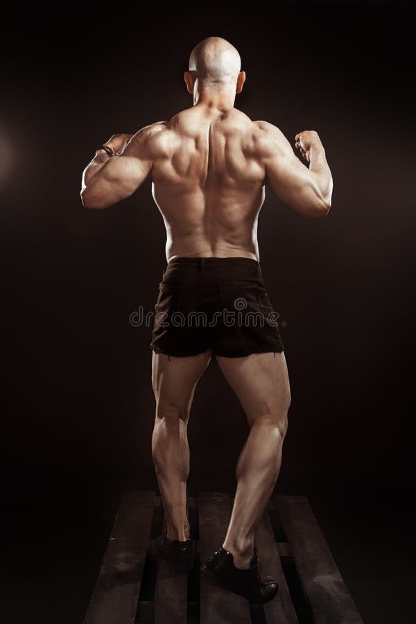 Athlete in Back Double Biceps Pose. Bodybuilder Showing Muscles on ...