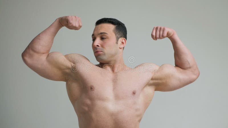 Bodybuilder Shows Strong Biceps on a White Background Stock Footage ...