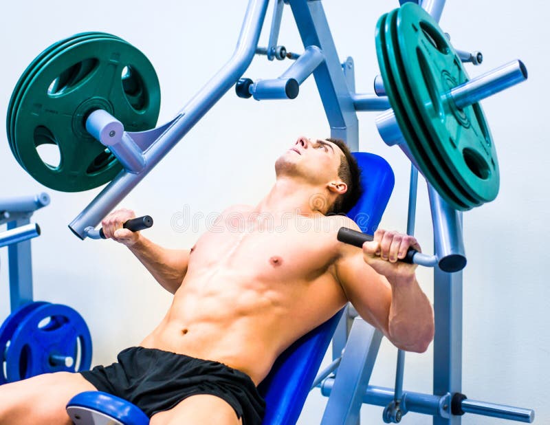 Bodybuilder with simulator stock photo. Image of athletic - 34894974