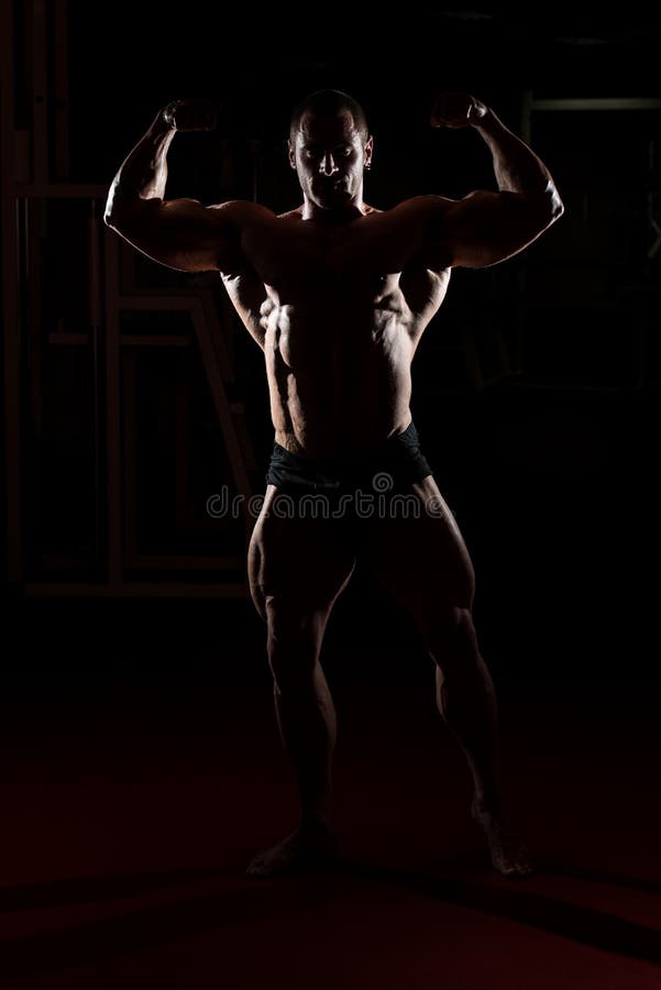 Bodybuilder Standing in the Gym and Flexing Muscles Stock Image - Image ...