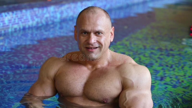 Bodybuilder Strains Muscles in Water of Indoor Stock Footage - Video of ...