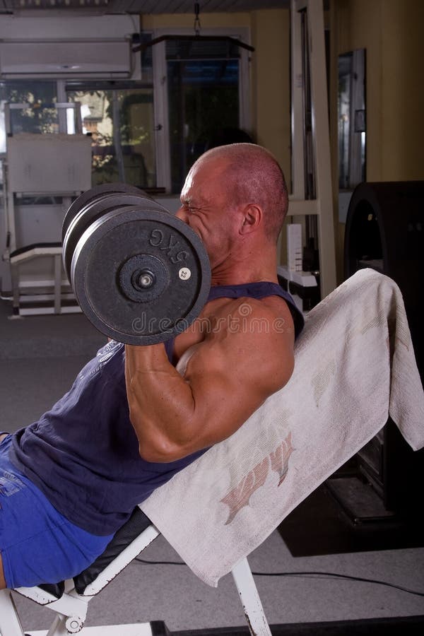 Bodybuilder training stock photo. Image of dumbbell, curls - 12345104