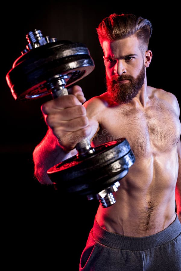 Bodybuilder Training with Dumbbell Isolated on Black with Dramatic ...