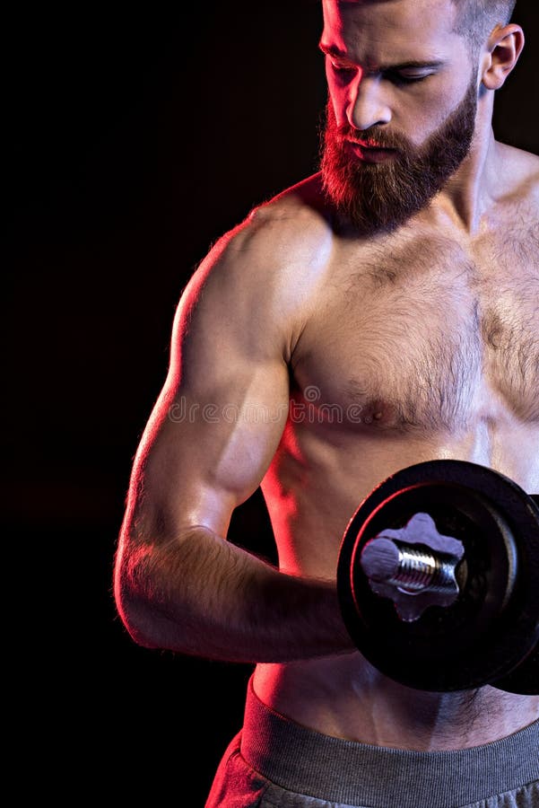 Bodybuilder Training with Dumbbell Isolated on Black with Dramatic ...