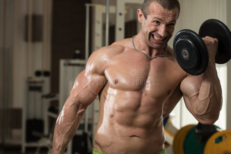 Bodybuilder Working Out Biceps in a Health Club Stock Photo - Image of ...