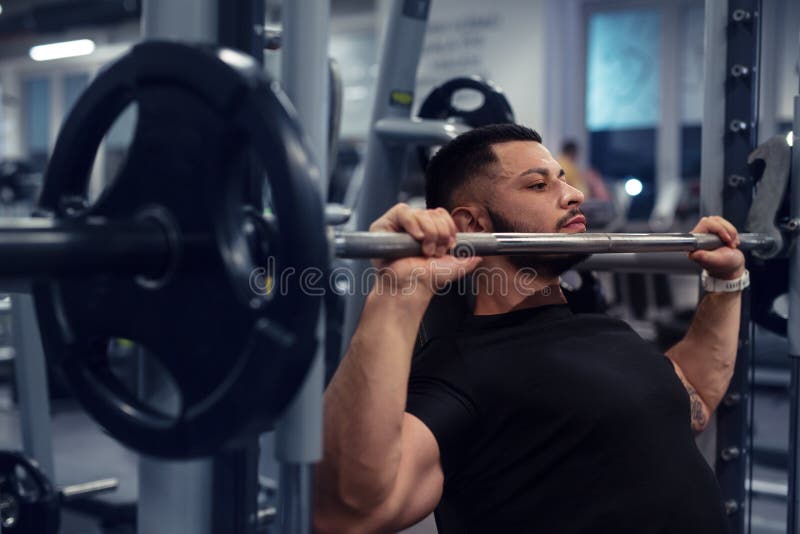 Bodybuilder Working Out in Gym with Determination Stock Photo - Image ...