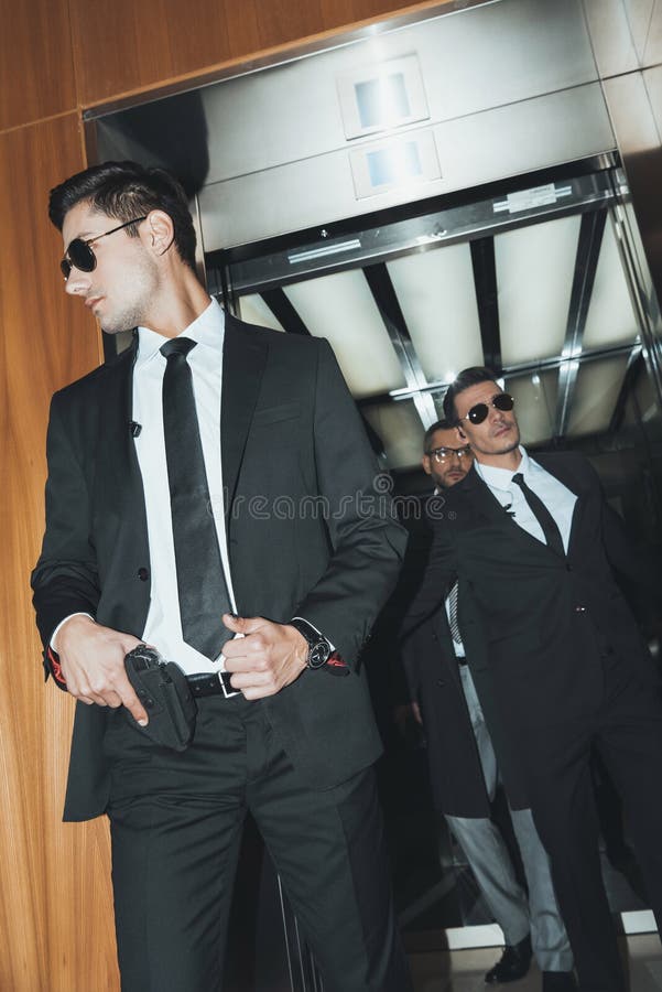 Bodyguard Putting Hand on Gun when Going Out from Elevator Stock Photo ...