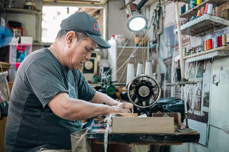 A Tailor is Fixing a Broken Bag Editorial Stock Image - Image of ...