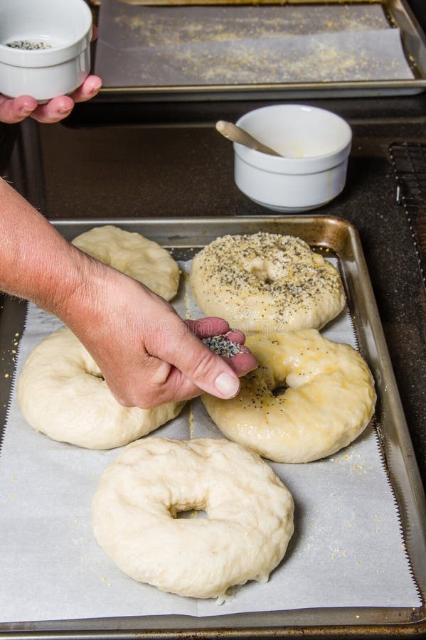 Boiled Bagels Being Seasoned for Baking Stock Image - Image of baked ...