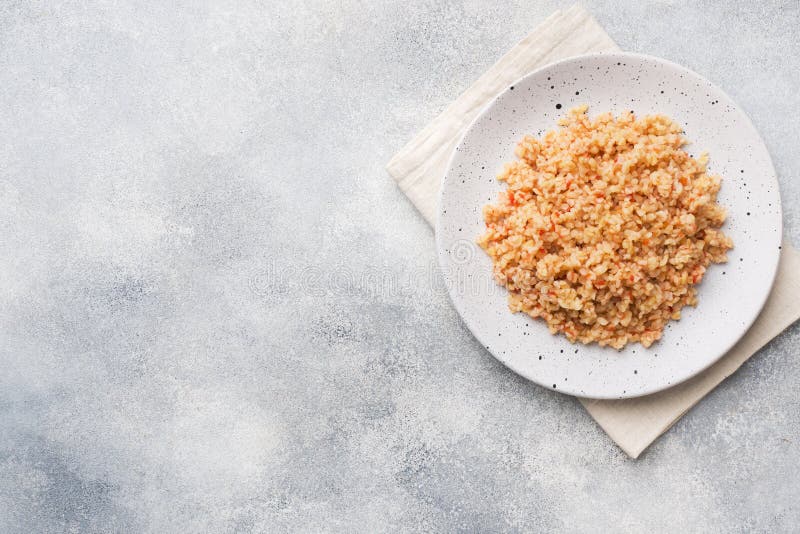 Boiled Bulgur with Tomatoes in a Ceramic Plate Stock Photo - Image of ...