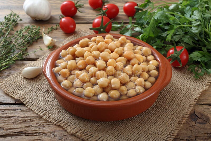 Add Boiled Chickpeas To Garlic with Lemon Juice in a Ceramic Mortar ...
