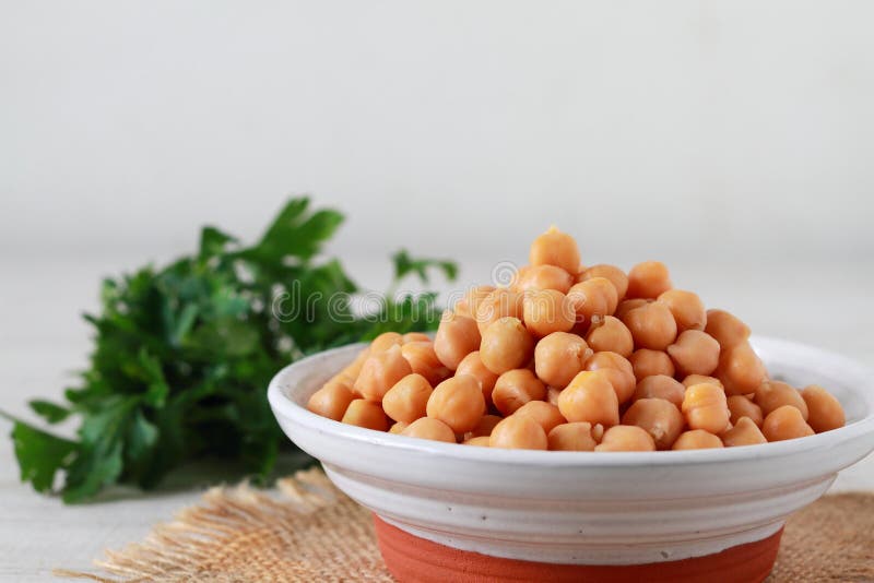 Add Boiled Chickpeas To Garlic with Lemon Juice in a Ceramic Mortar ...