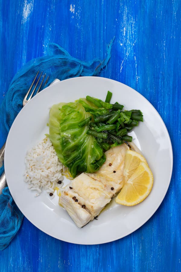 Boiled Cod Fish with Rice and Vegetables on White Plate Stock Photo ...