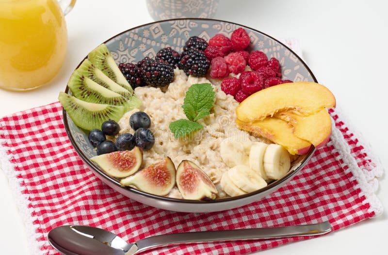 Boiled Oatmeal with Fruit in a Round Plate on a White Table, Healthy ...