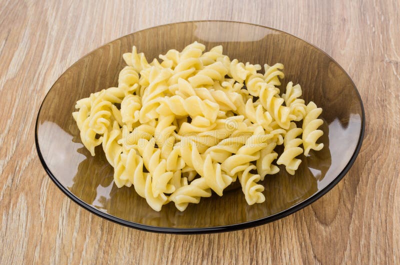 Pasta Fusilli, Fork in Plate, Ketchup and Mayonnaise on Table Stock ...
