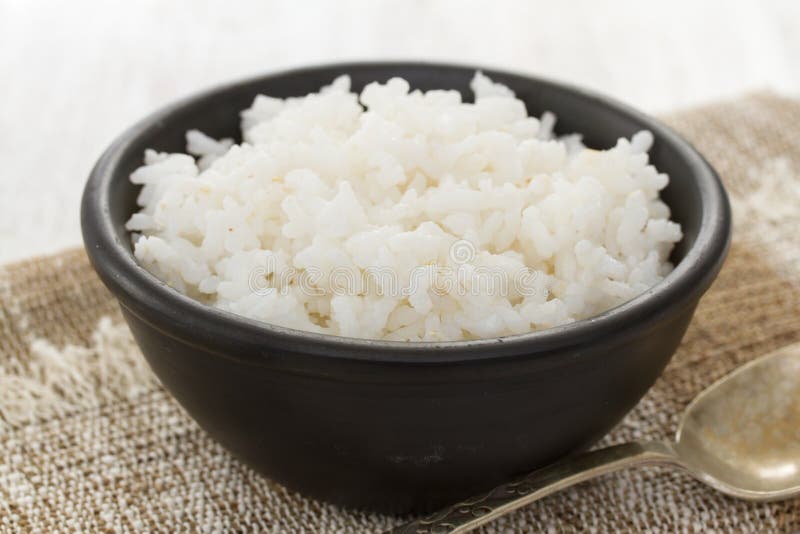Boiled Rice in Black Bowl in Wooden Background Stock Photo - Image of ...