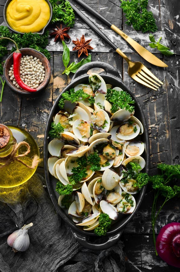 Boiled Shellfish in Shells with Garlic and Parsley in a Black Plate ...