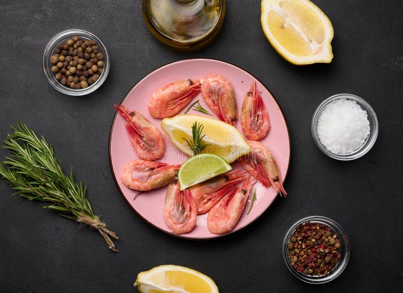 Boiled Shrimp, Lemon and Lime Slices, Spices on a Black Table, Top View ...