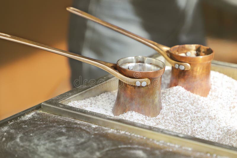 Boiled Traditional Turkish Coffee in the Pots on Sand. Stock Photo ...
